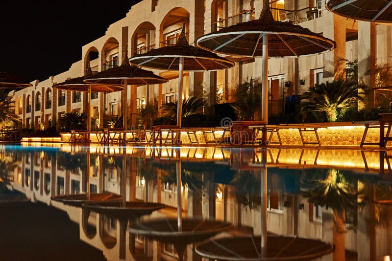 Illuminated Hotel with a Swimming Pool at Night. Evening Lights at ...