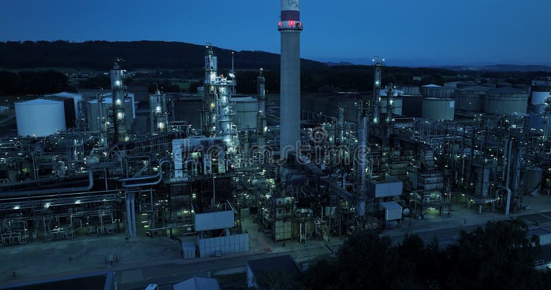 An Illuminated Industrial Complex Featuring Buildings and Towers in the ...