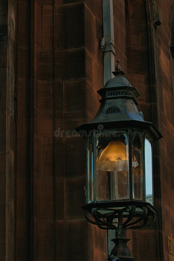 Illuminated Lantern on Stone Building Facade in Manchester, UK Stock ...
