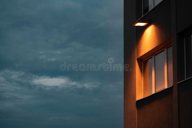 Illuminated Light Above a Window of a Multistory Building in the ...