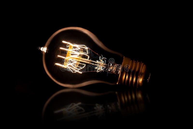 Illuminated Light Bulb with Reflection Lying Stock Image - Image of ...