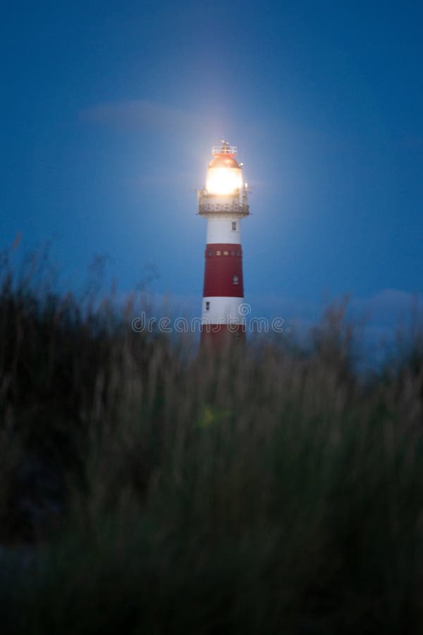 Illuminated Lighthouse in the Evening Stock Image - Image of blue ...