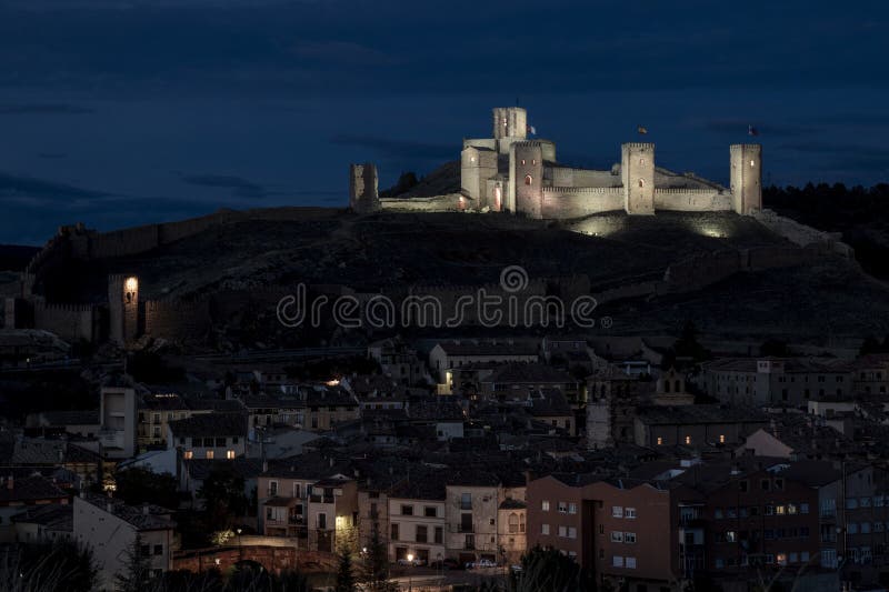 Medieval Castle Towering Over a Quiet Village at Night Under a Deep ...