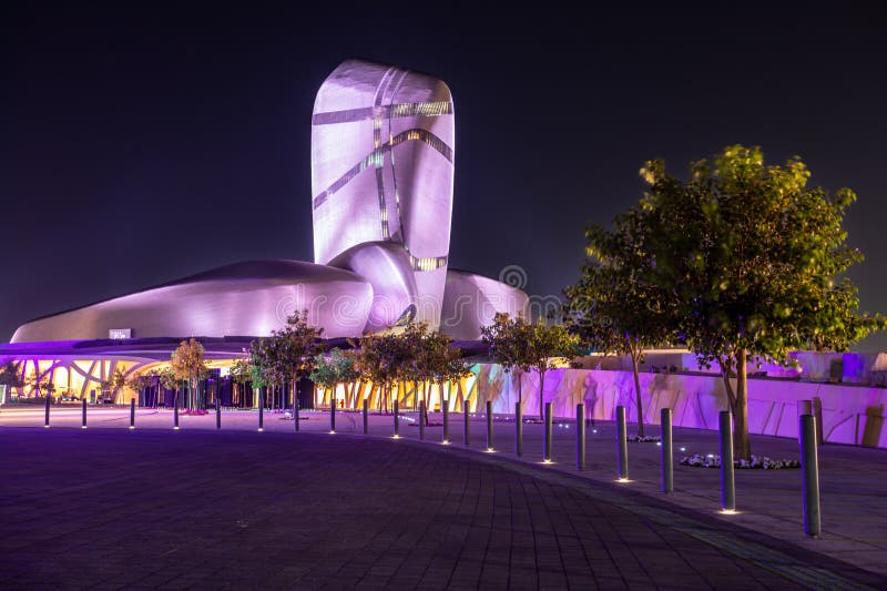 Illuminated Modern Building and Square with Trees in the Center of Al ...