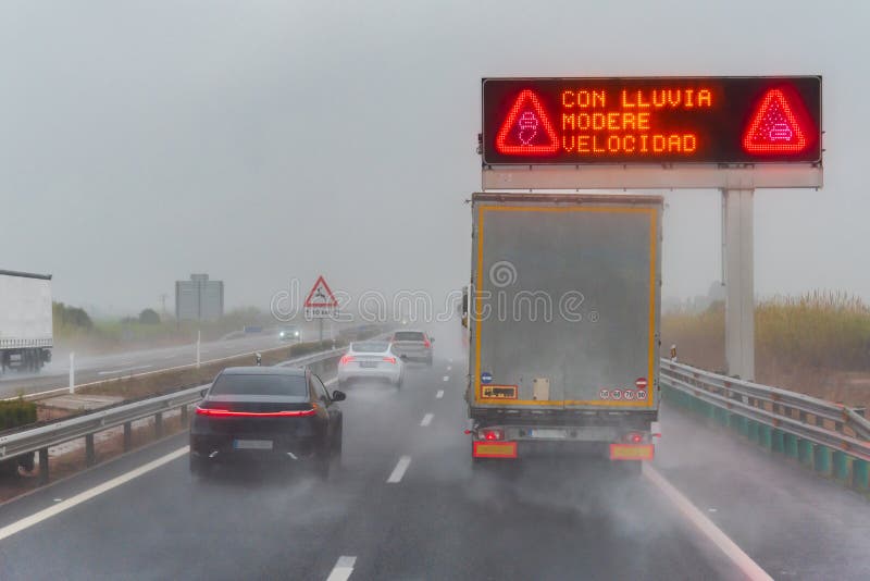 Illuminated Panel on a Highway with the Legend in Rain, Moderate Speed ...