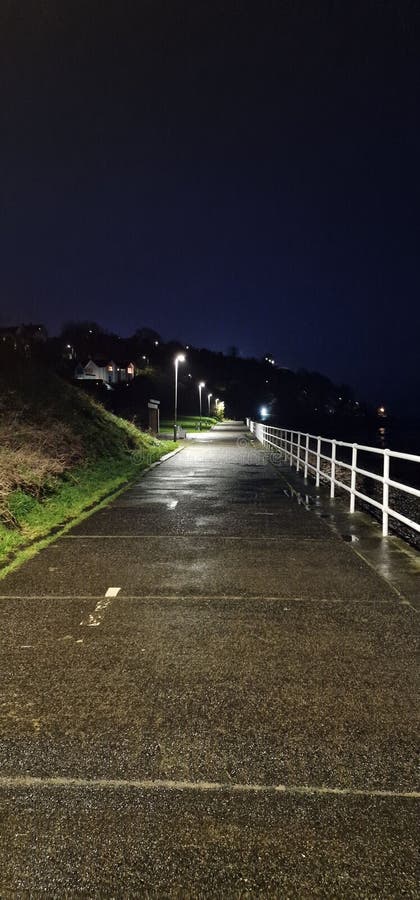 Illuminated Pathway at Night Leading To a Beach, with a Set of Steps ...