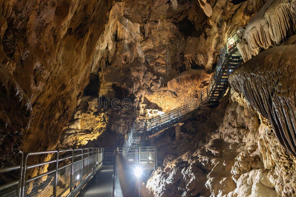 Illuminated Pathway in Su Mannau Cave Stock Photo - Image of cave ...