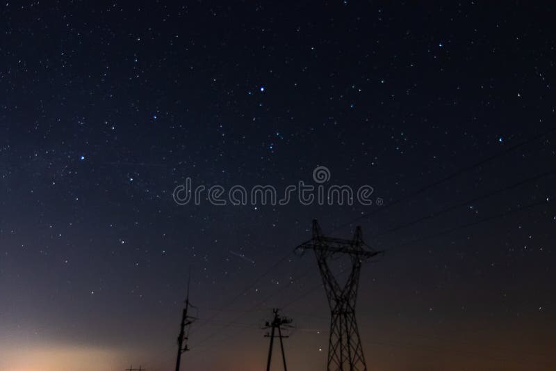 Illuminated Power Lines Under a Starry Night Sky Stock Image - Image of ...