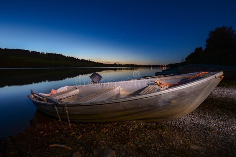 Rowboats on lake at dusk stock image. Image of algonquin - 20167665