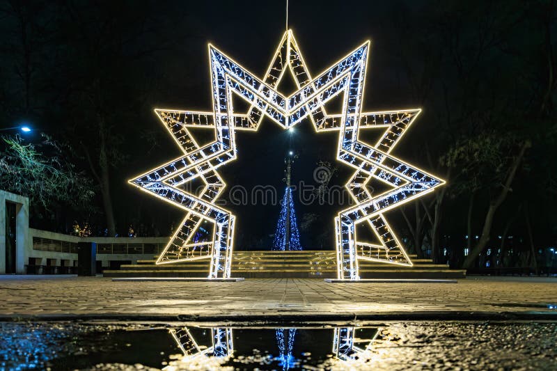 Illuminated Star Sculpture in Night Park Reflecting in Water Stock ...