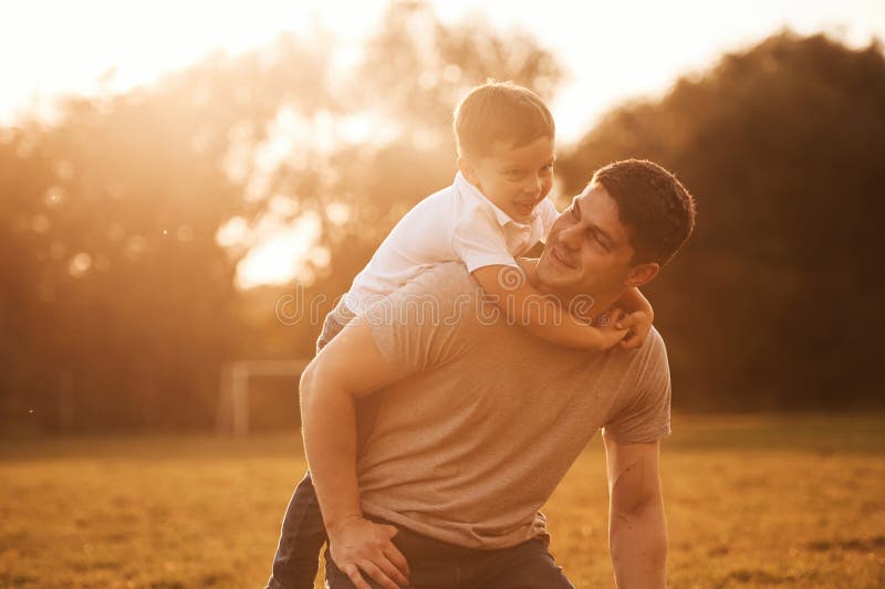 Playing and Having Fun. Father and Son is Indoors at Home Together ...