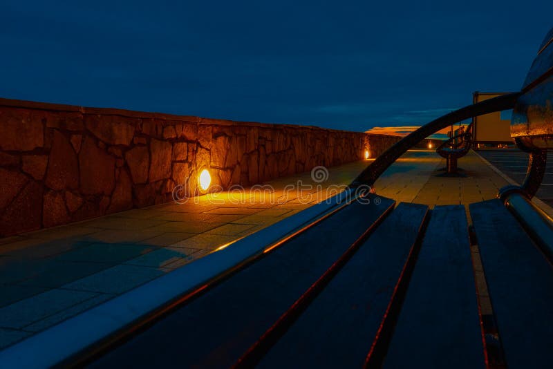 Illuminated Walking Path Way at Night and Empty Sitting Bench. Warm and ...