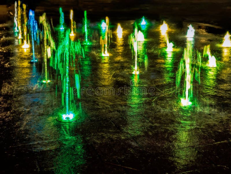 Illuminated Waterspout Fountain at Night Stock Image - Image of blue ...