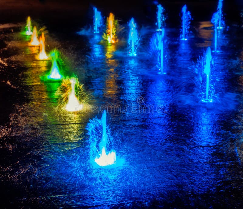 Illuminated Waterspout Fountain at Night Stock Photo - Image of lights ...