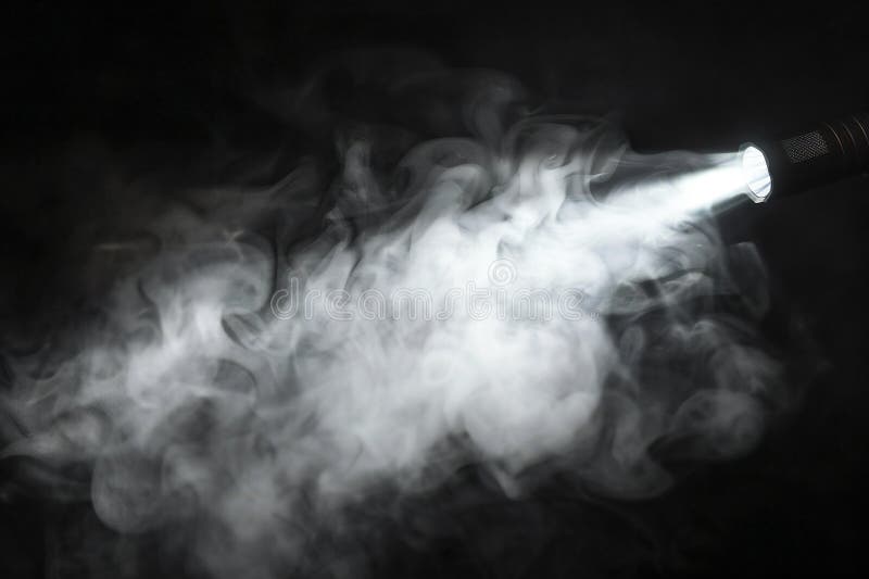 A Flashlight Beam Shining through Smoke on Black Background. the Light ...