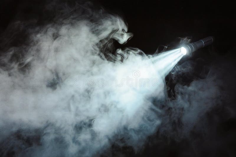 A Flashlight Beam Shining through Smoke on Black Background. the Light ...
