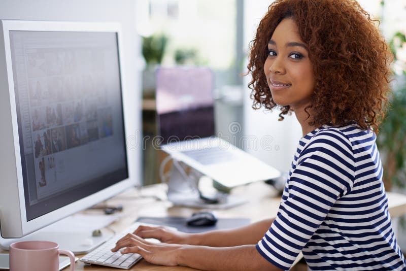 Im Aiming for the Top. a Young Woman at Work on a Computer in an Office ...