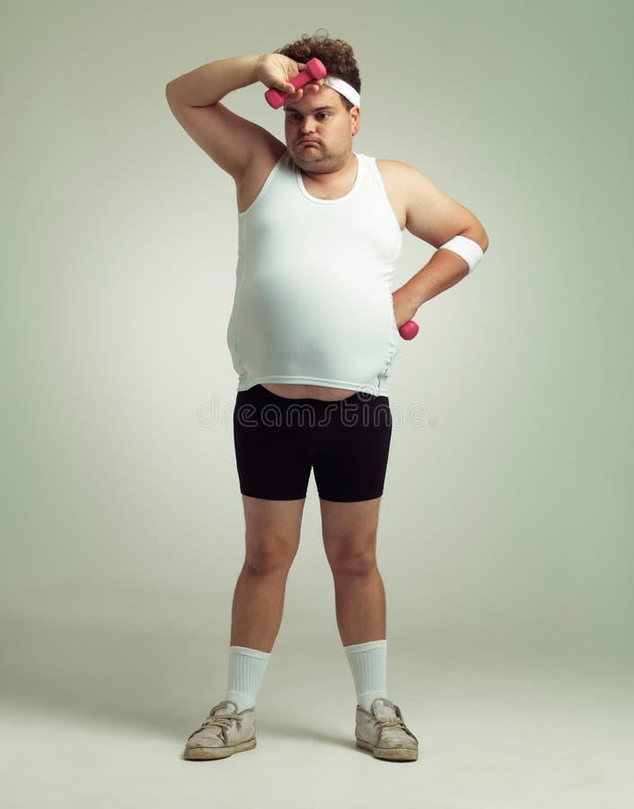 Im Half Way There. an Overweight Man Tired after Lifting Dumbbells ...
