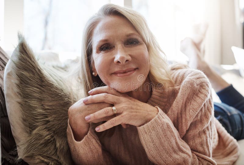 Im On My Time Now An Attractive Mature Woman Relaxing On The Sofa At