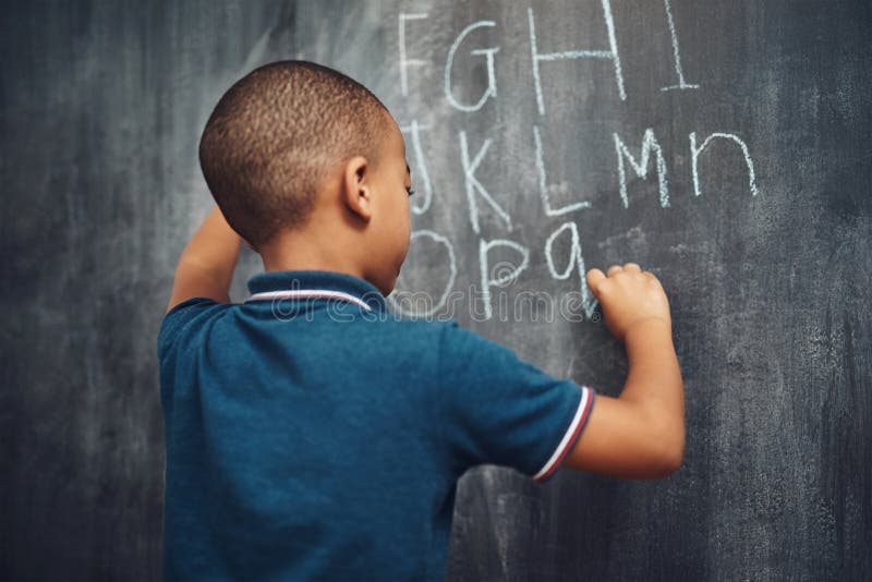 Im Practising the Alphabet Today. a Young Boy Writing on a Blackboard ...
