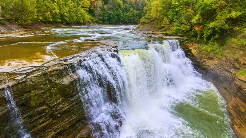 Aerial Along Edge of Huge Raging Waterfall Pouring Over Cliffs ...