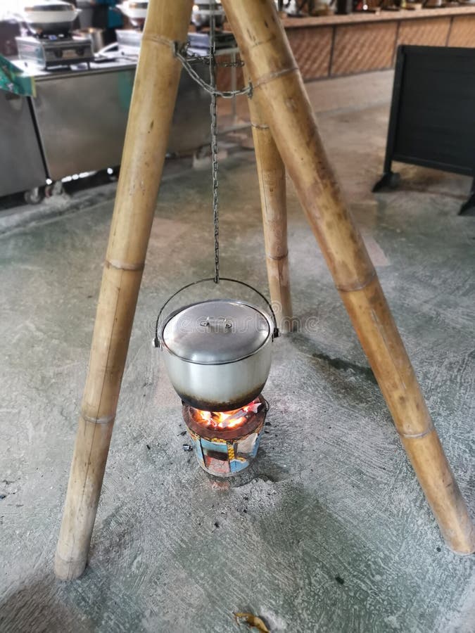 Aluminum Cooking Pot with Handle Hanging on the Bamboo Pole Cooking on ...