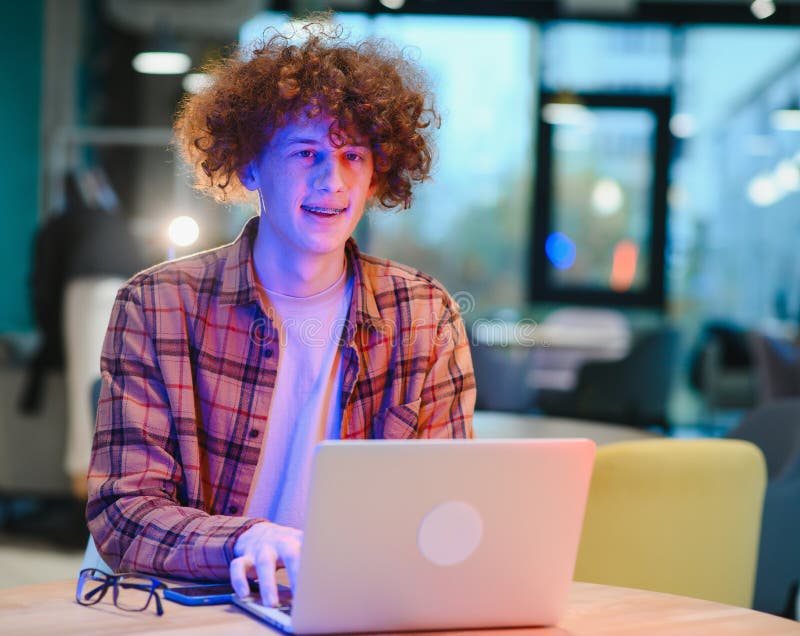 Image of Amazing Young Man Sitting in Cafe while Using Laptop Computer ...