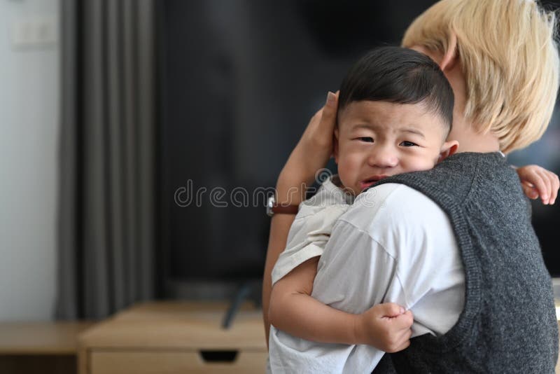 Mother Holding Her Crying Toddler Boy and Trying To Calm Him Down at ...