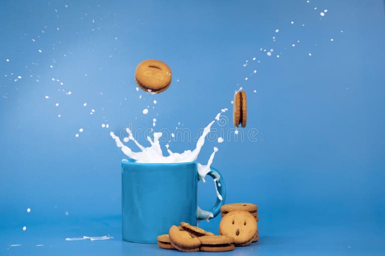 Image of an Assortment of Doughnuts Falling into a Cup of Milkk Stock ...