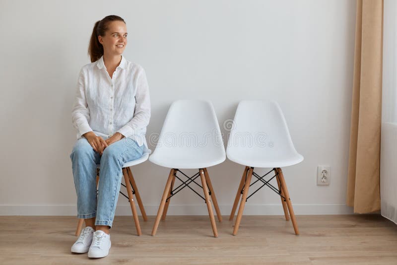 Image Of Attractive Dark Haired Woman Wearing White Shirt And Jeans