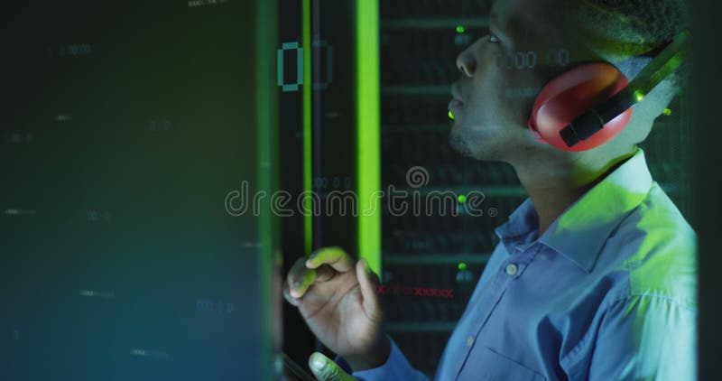 Image of Binary Coding Over African American Male Engineer Using Digital Tablet at Server Room ...