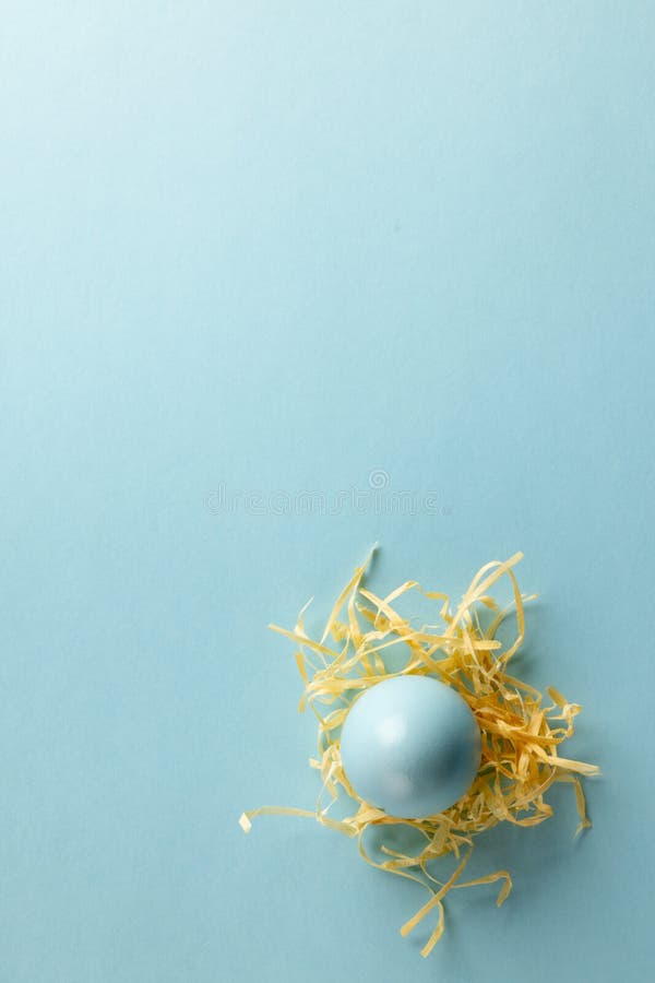 Image of Blue Easter Egg in Straw and Copy Space on Blue Background ...