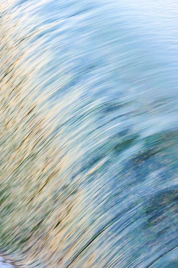 The Image is a Blurry Reflection of a Waterfall in the Water Stock ...