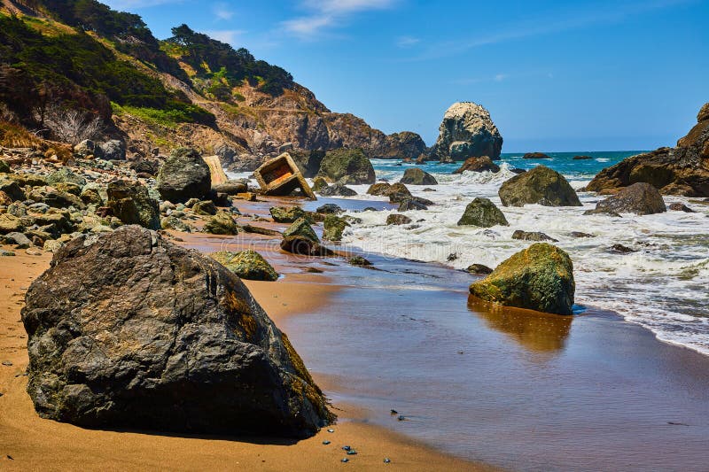Boulder Strewn Beach with Crashing Ocean Waves and Destroyed Concrete ...