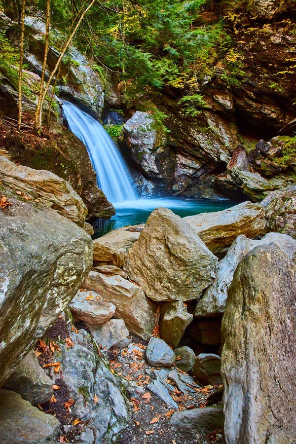 Boulders by River Surrounded with Cliffs and Waterfall into Blue River ...