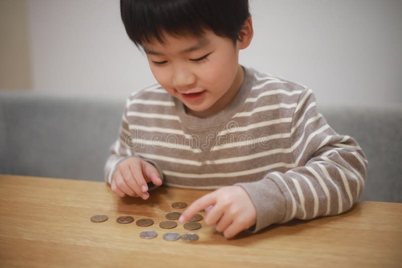 Boy counting coins stock image. Image of toddlers, play - 238943907