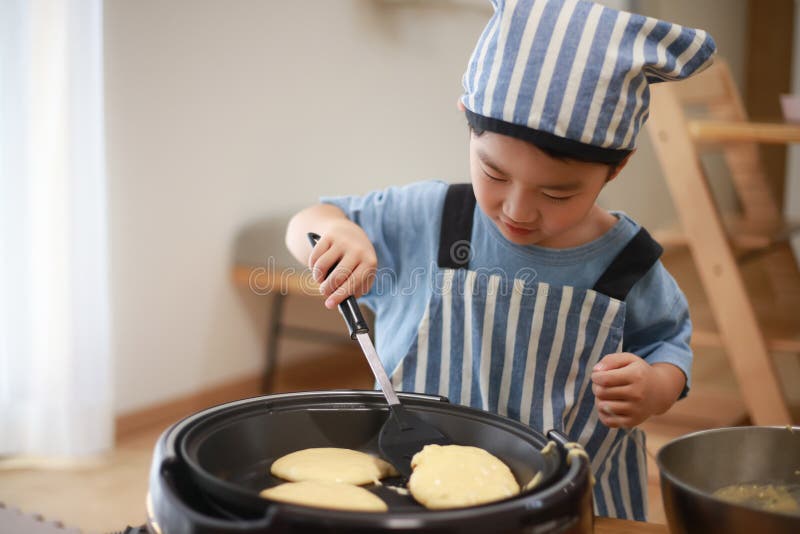 Boy making pancakes stock image. Image of home, cookware - 248724589