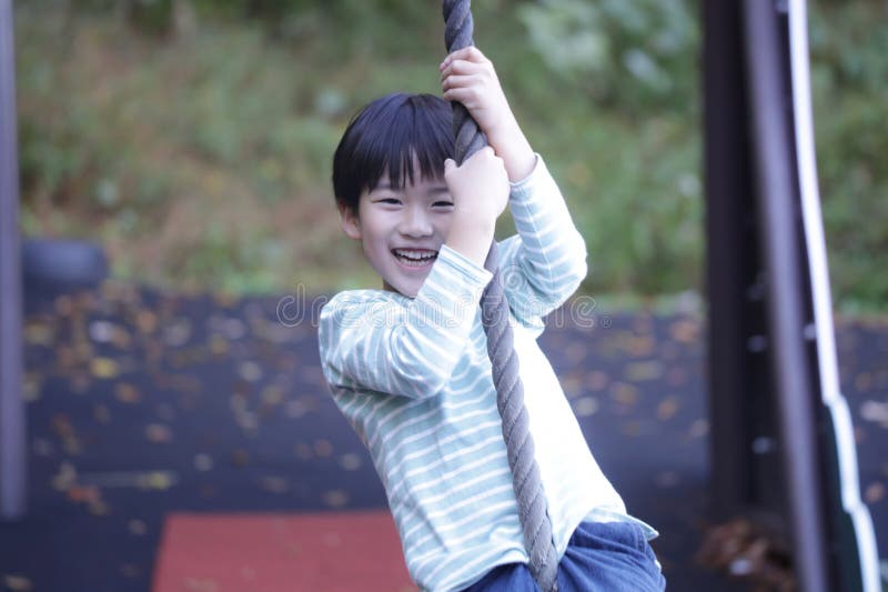 Boy Playing with Tarzan Rope Stock Image - Image of energetic, people ...