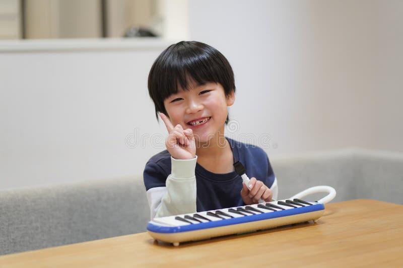 Boy Practicing Keyboard Harmonica Stock Image - Image of keyboard ...