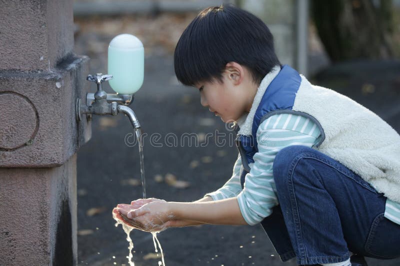 Boy washing his hands stock photo. Image of clean, wash - 324704338