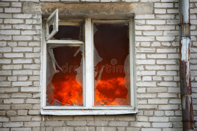 Image of Brick House with with Fire in Window. Stock Image - Image of ...