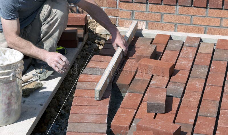 Mason laying brick stock photo. Image of tradesman, brick - 2112276