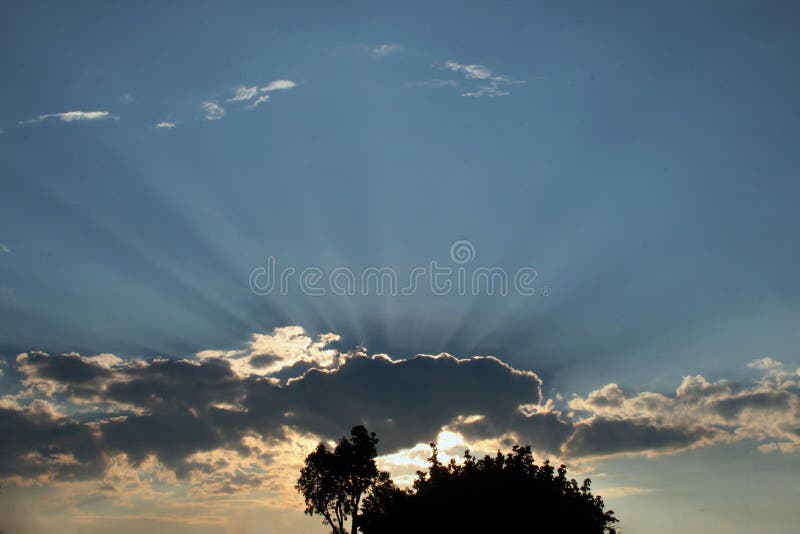 RADIATING CLOUDS and LIGHT SHAFTS Stock Photo - Image of sunset ...