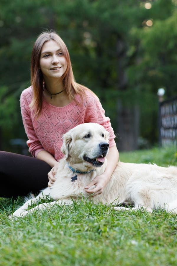 Image of Brunette and Dog Sitting on Lawn Stock Image - Image of ...