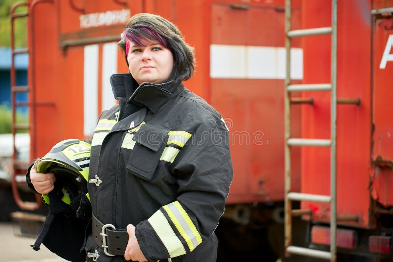 Image of Brunette Firefighter Standing Next To Firefighters Car. Stock ...