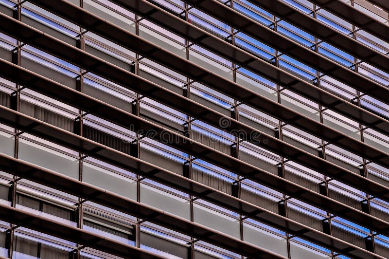 The Image is of a Building with a Lot of Windows and Metal Bars Stock ...