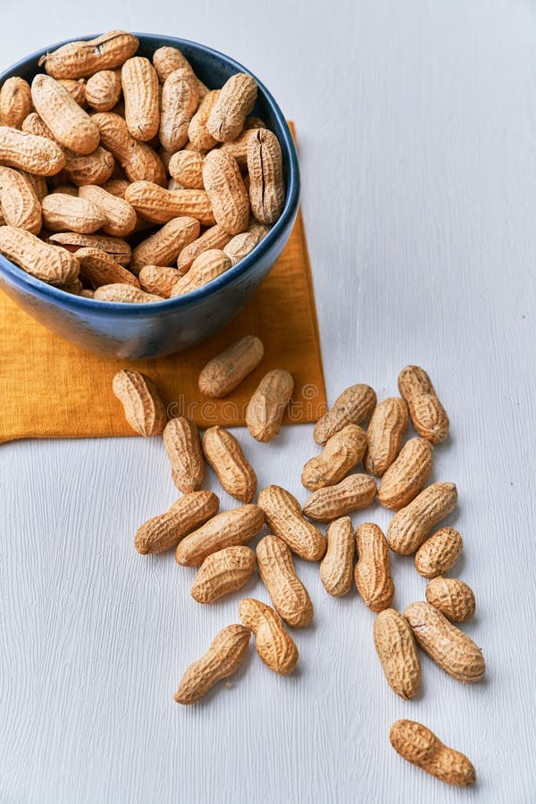 Image of Bunch of Peanuts in a Bowl on a Table Stock Photo - Image of ...