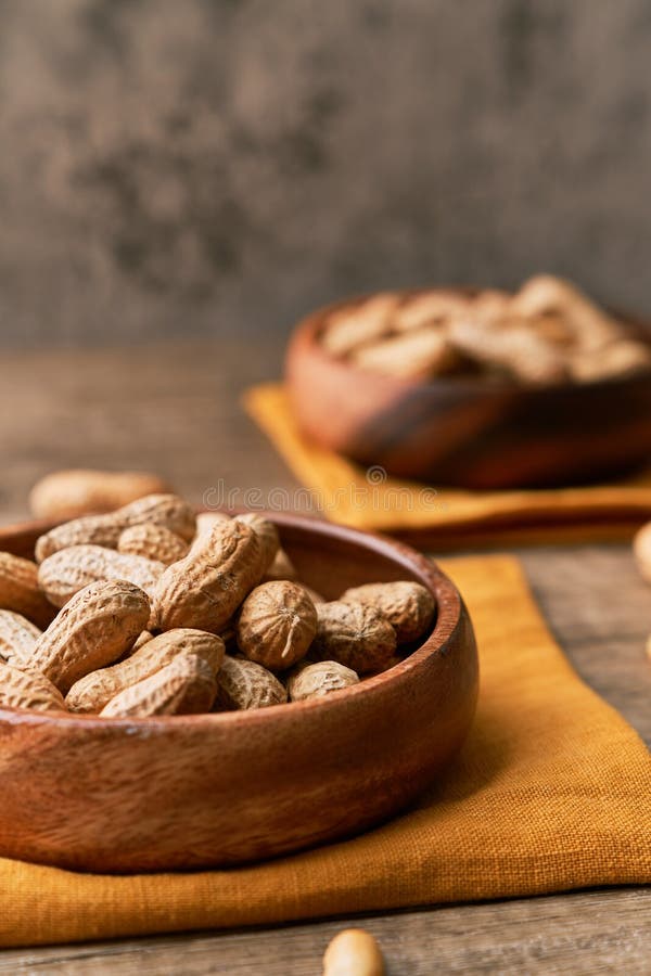 Image of Bunch of Peanuts in a Bowl on a Wooden Table Stock Photo ...