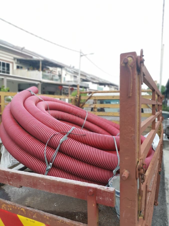 Bundle of Vermilion Red PVC Plastic Industrial Pipe Hose at the Back of ...