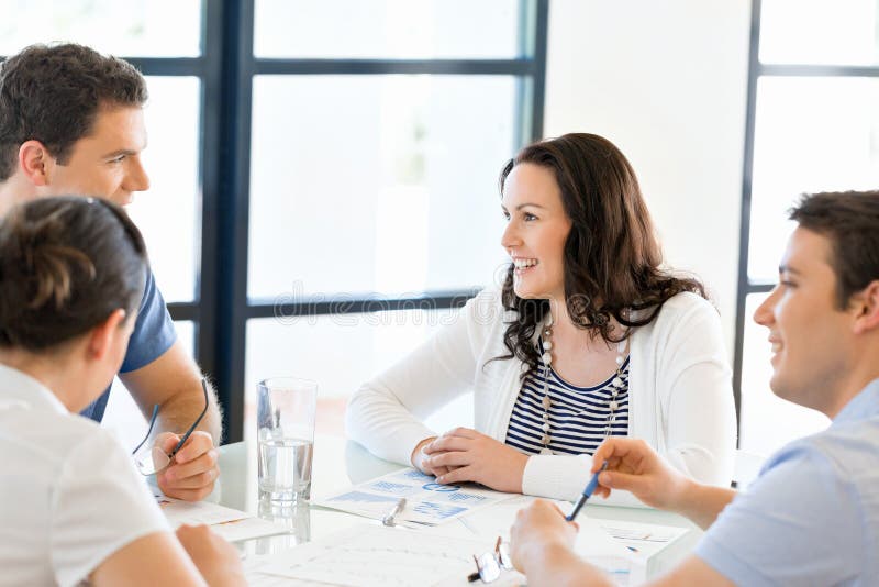 Image of Business Partners Discussing Documents and Ideas Stock Photo ...